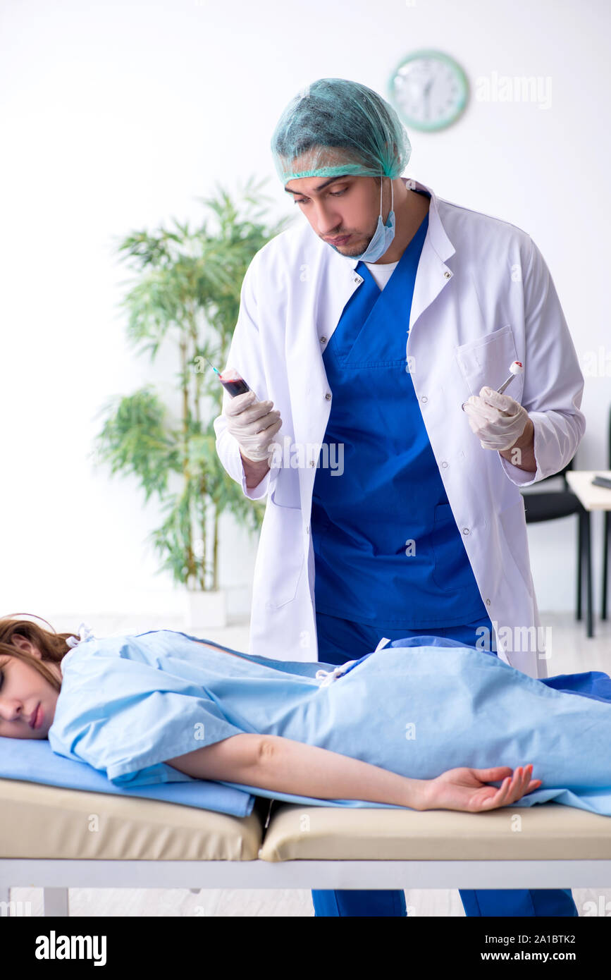 The female patient getting an injection in the clinic Stock Photo - Alamy