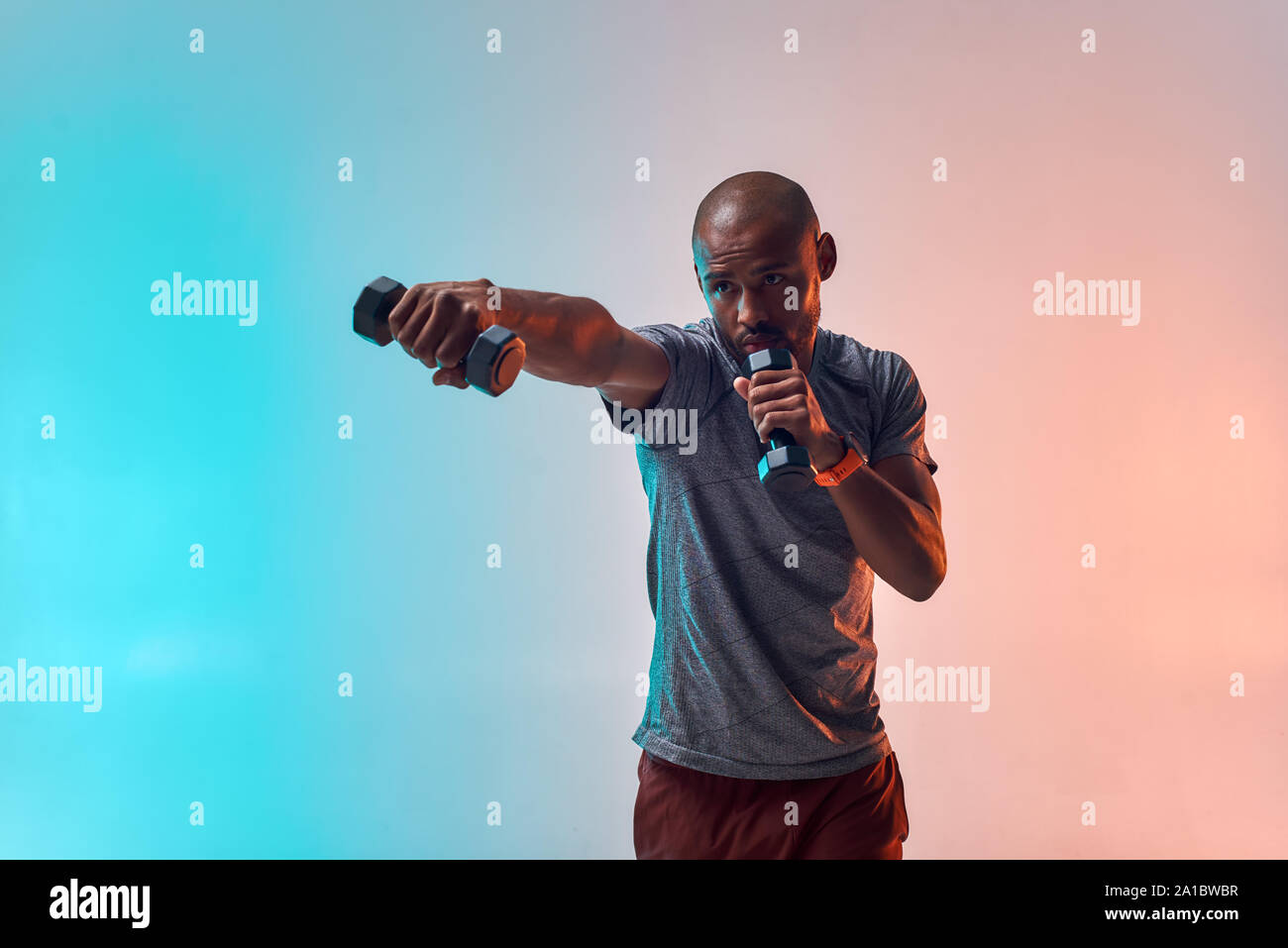 Perfect muscles. Strong young african man exercising with dumbbells ...
