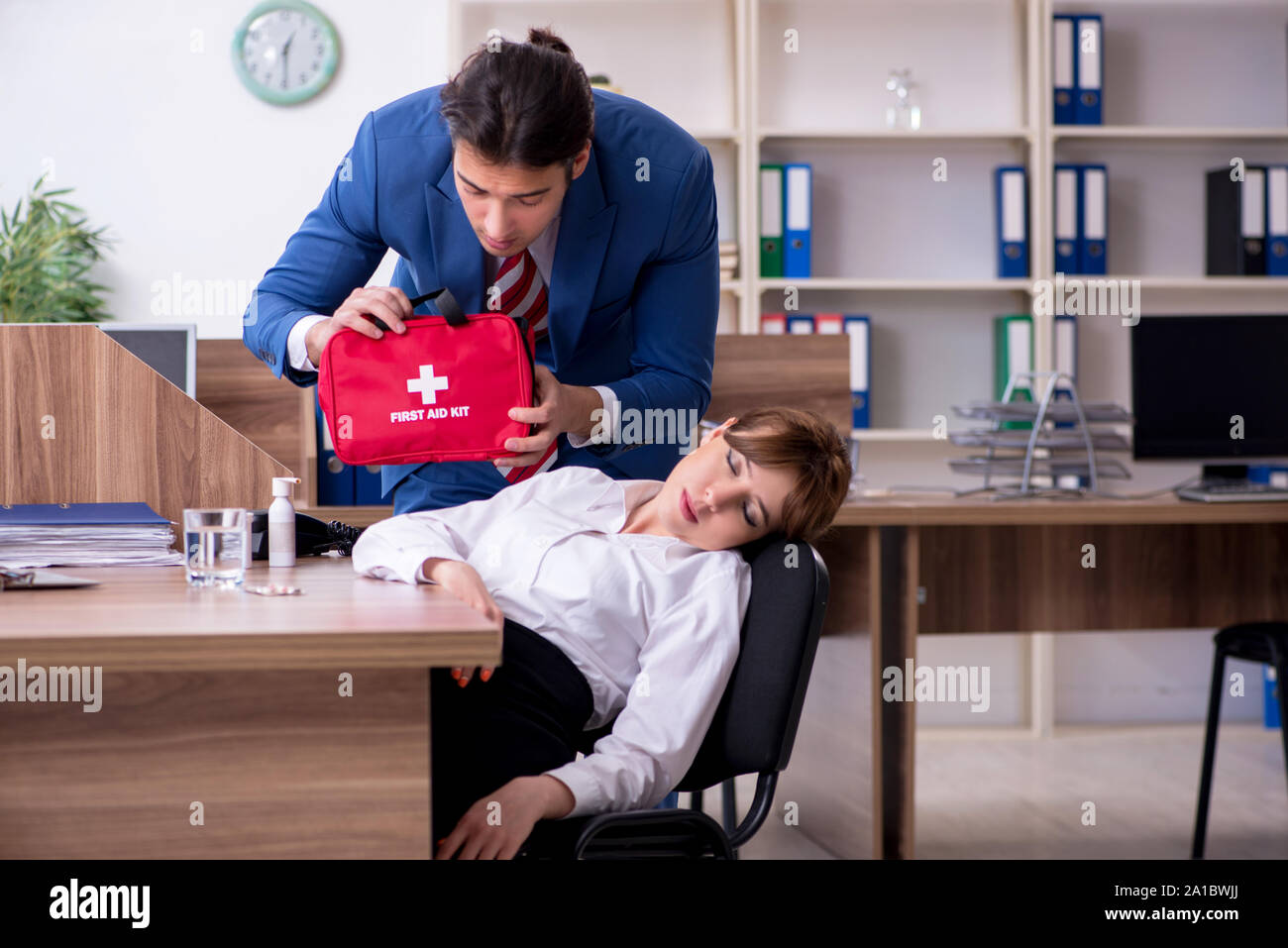 Employee receiving first aid in office Stock Photo - Alamy