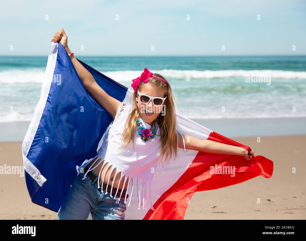 Happy French girl carries fluttering blue white red French flag of ...