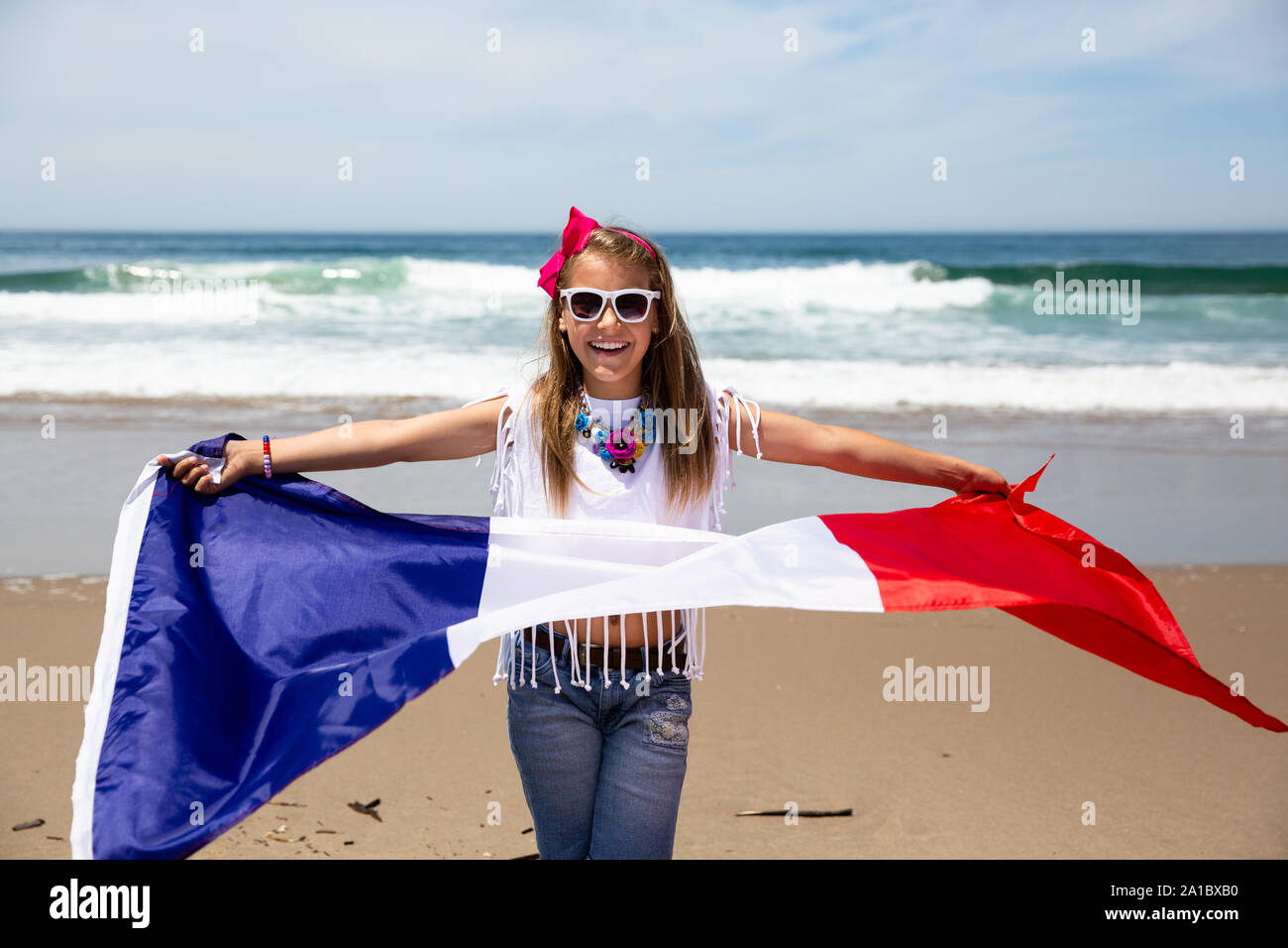 Happy French girl carries fluttering blue white red French flag of ...