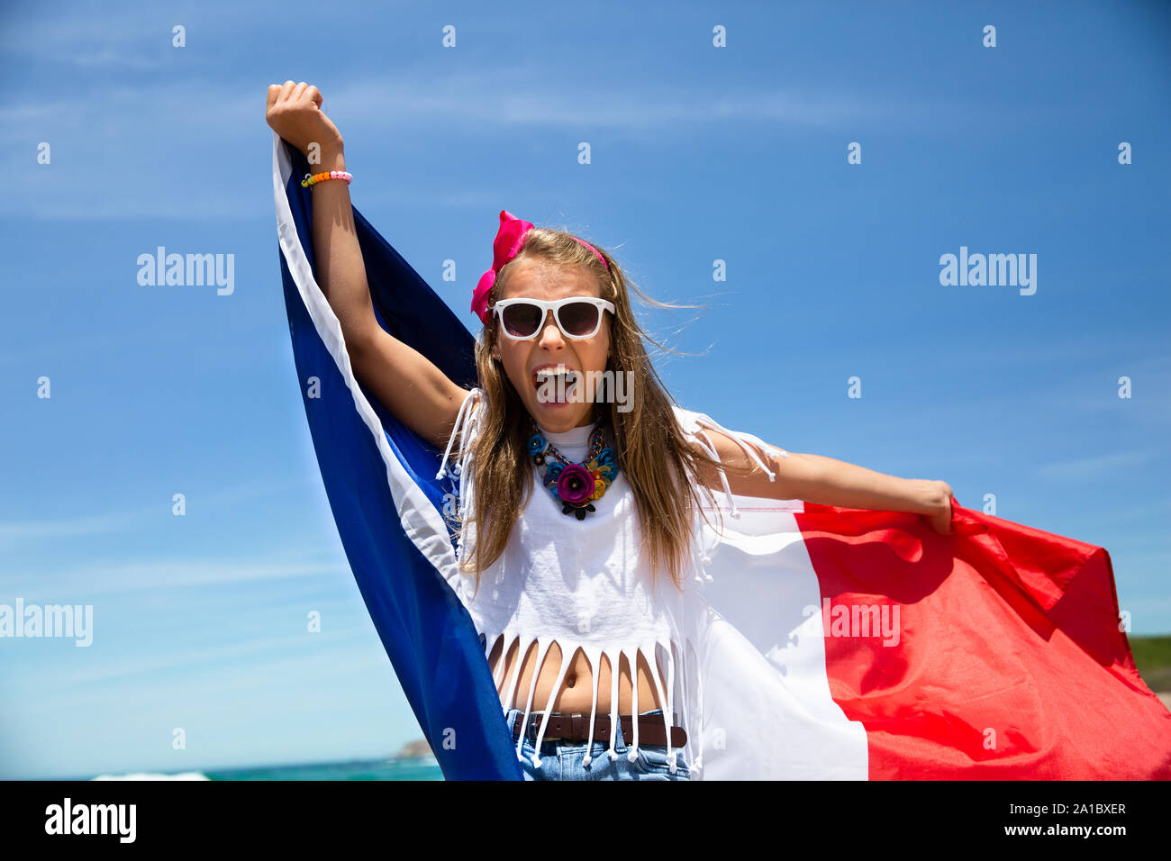 Happy French girl carries fluttering blue white red French flag of ...