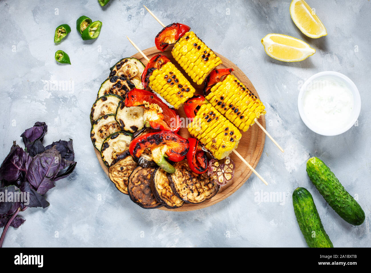 Assorted delicious grilled vegetables on a concrete background. Summer ...