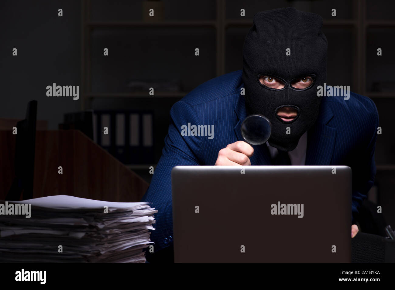 The male employee stealing information in the office night time Stock ...