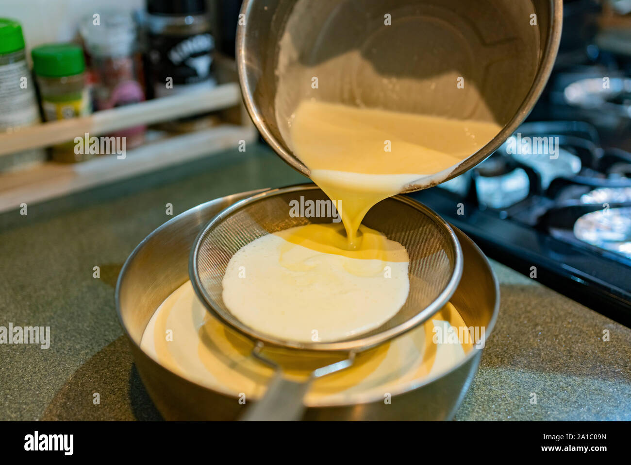 Close up shot of pouring the butter to another pan with a sifter at Las ...
