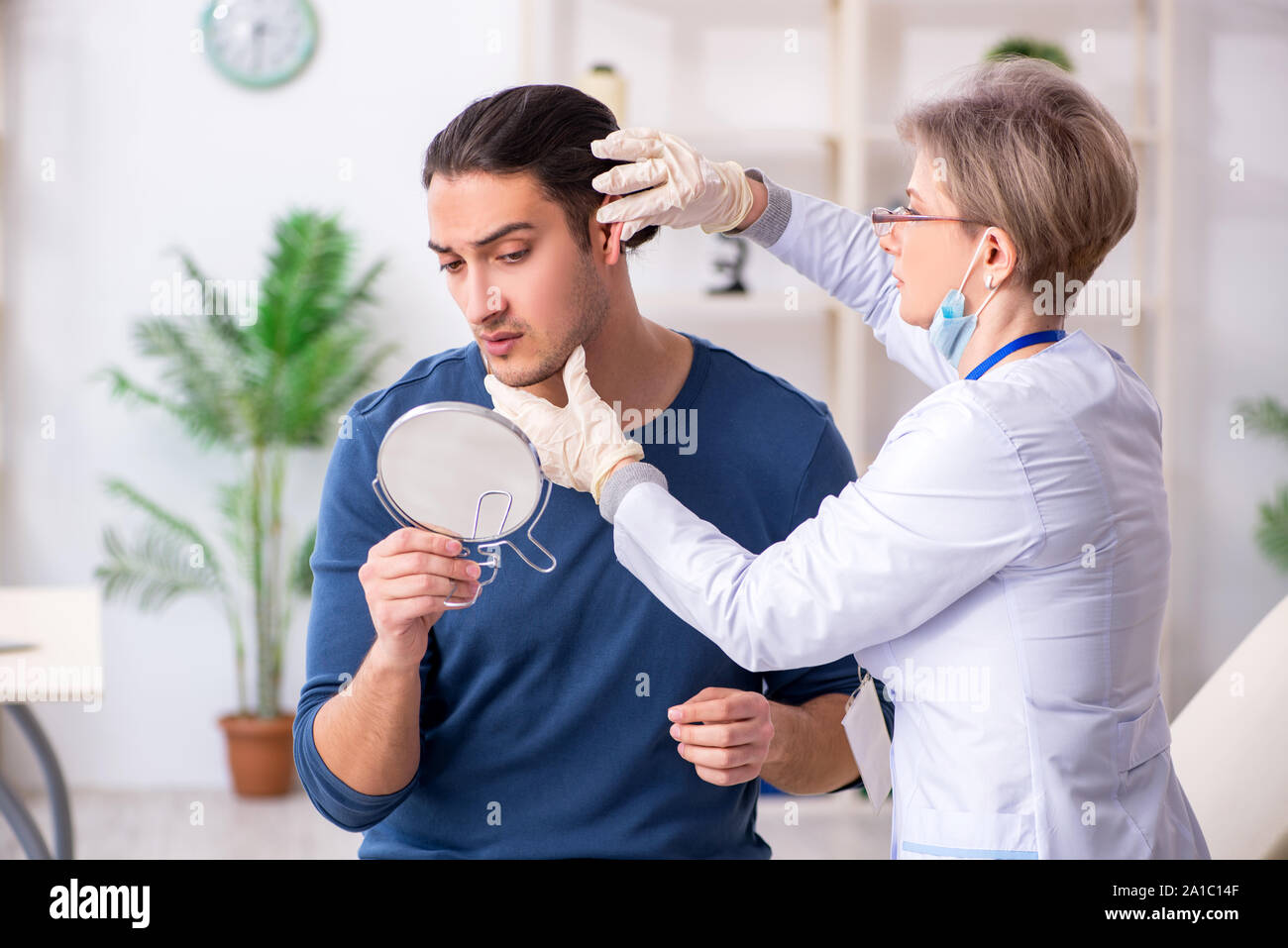 Young woman mirror face inspecting hi-res stock photography and images ...