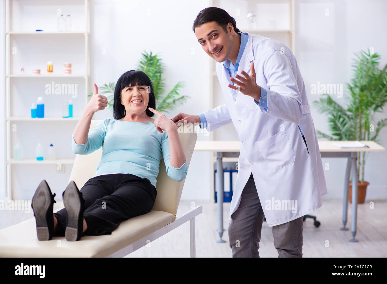 Old woman visiting young doctor dentist hi-res stock photography and ...