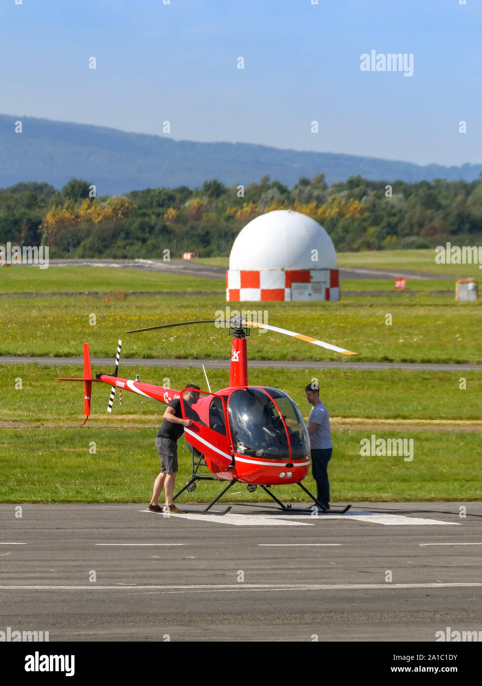 GLOUCESTER, ENGLAND - SEPTEMBER 2019: Small Robin R22 helicopter on the ...