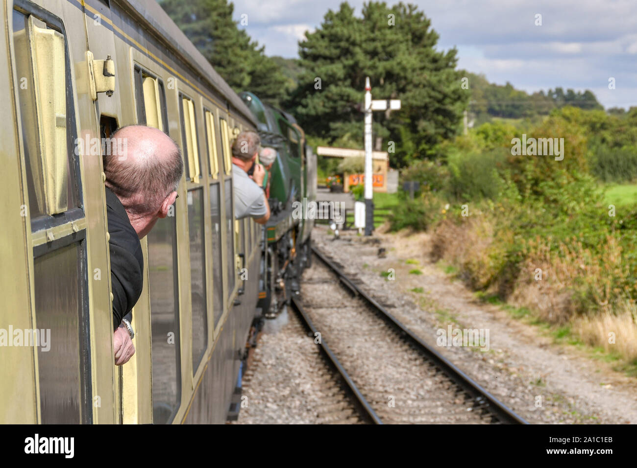 GLOUCESTERSHIRE, ENGLAND - SEPTEMBER 2019: Rail enthusiasts leaning out ...