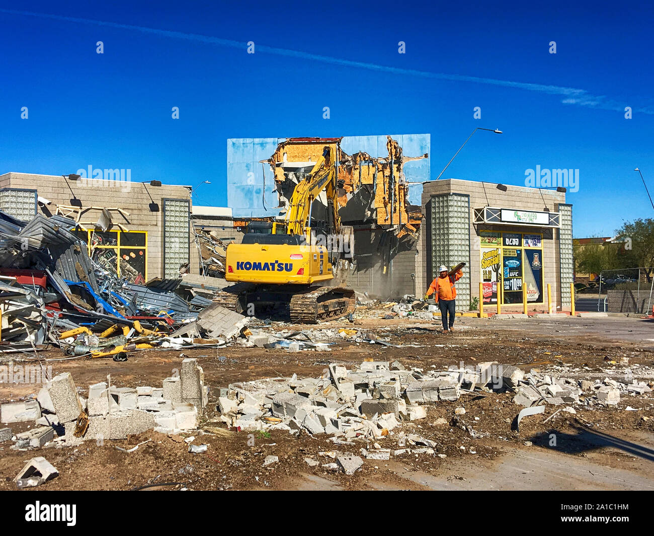 Demolition of a store building by a tracked vehicle in downtown Tucson ...