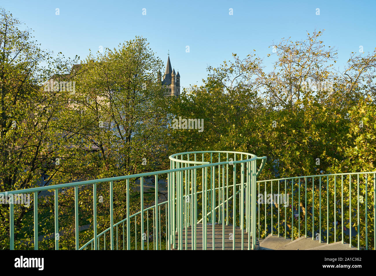 Green handrail on a bridge with a view of Cologne downtown Stock Photo ...
