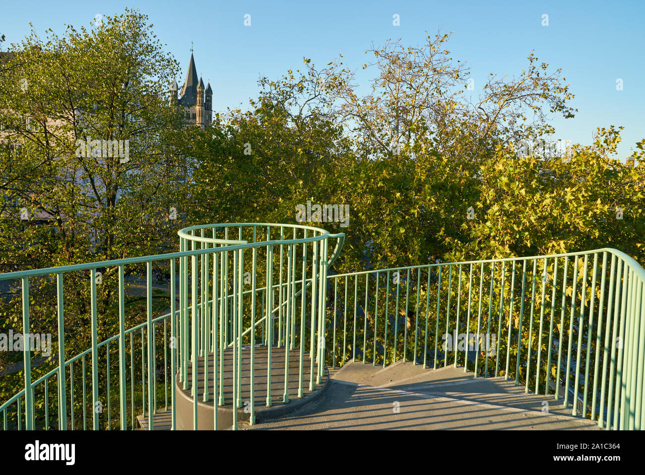 Green handrail on a bridge with a view of Cologne downtown Stock Photo ...