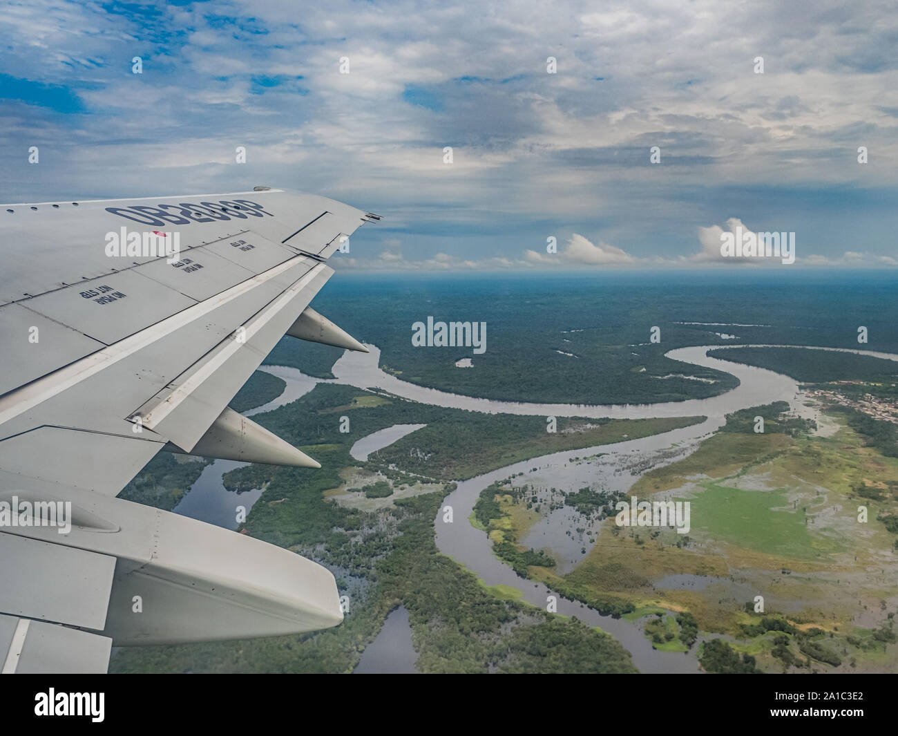 View from airplane window. Wing of an airplane flying above the clouds ...
