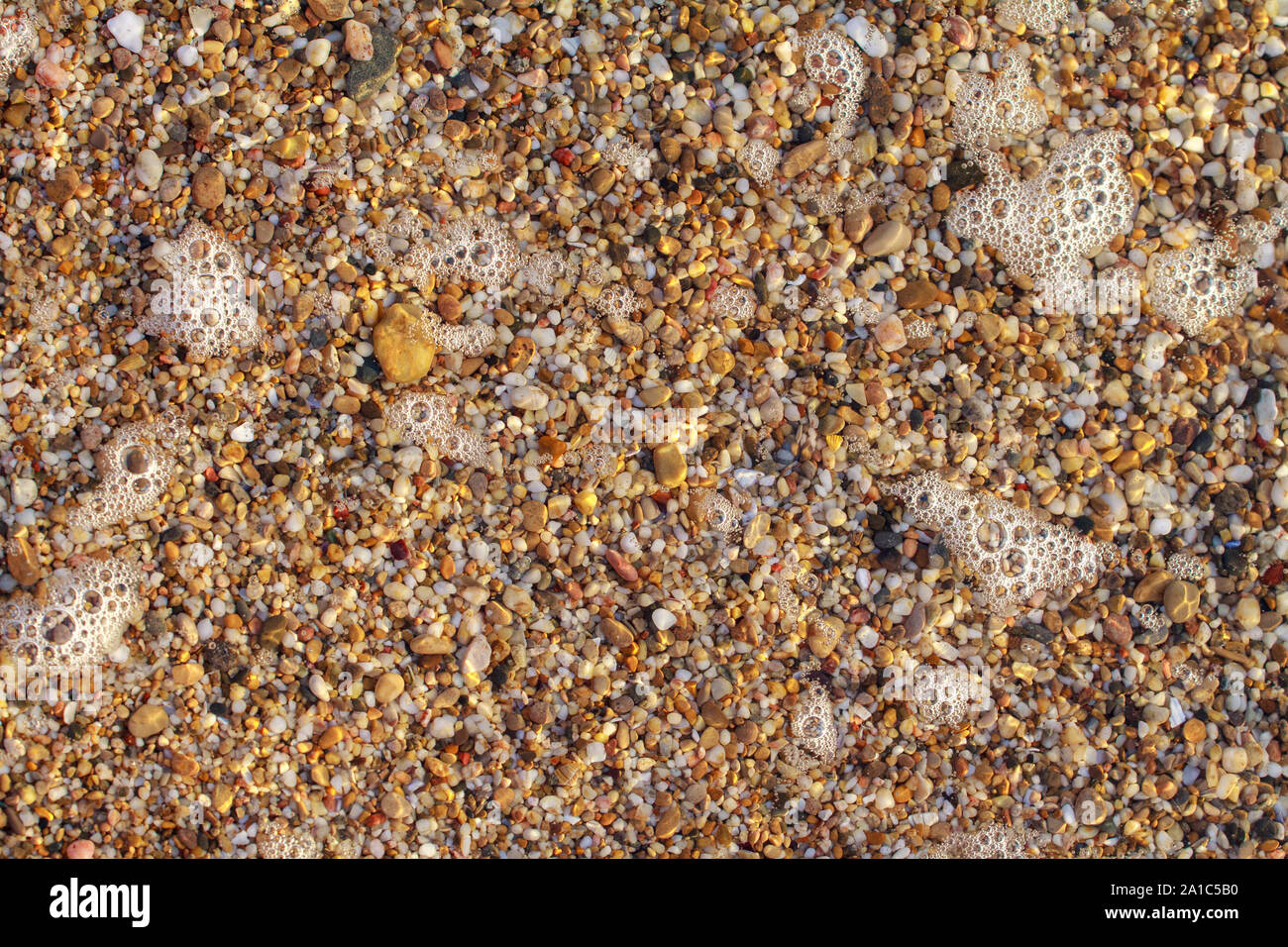 sea pebbles colored granite on the beach background stones. The shore ...