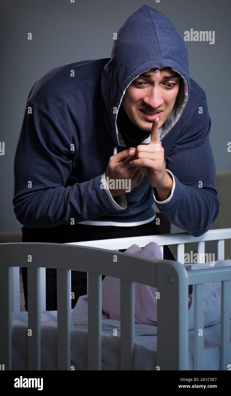 The criminal stealing baby in human child traficking concept Stock ...