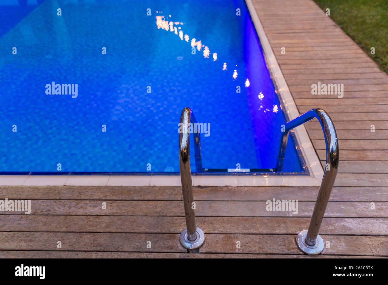 blue color pool , poolside handle wood Stock Photo - Alamy