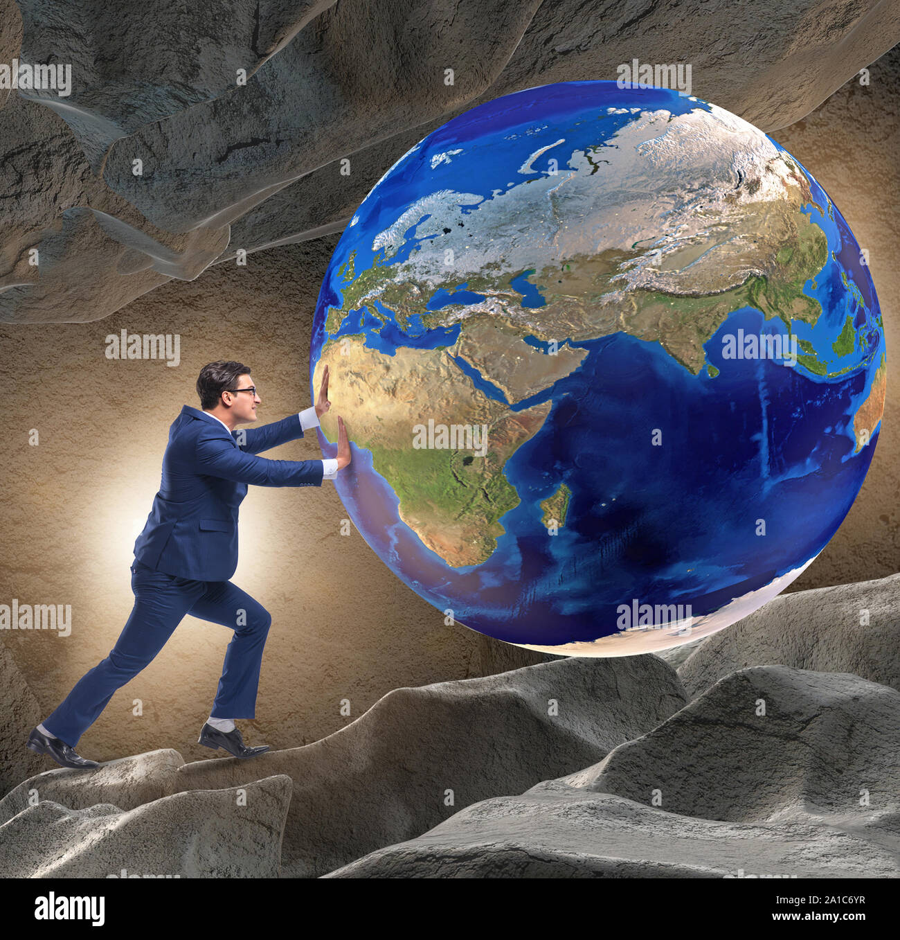The businessman pushing the world in challenge concept Stock Photo - Alamy