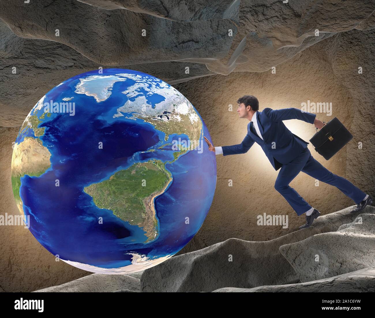 The businessman pushing the world in challenge concept Stock Photo - Alamy
