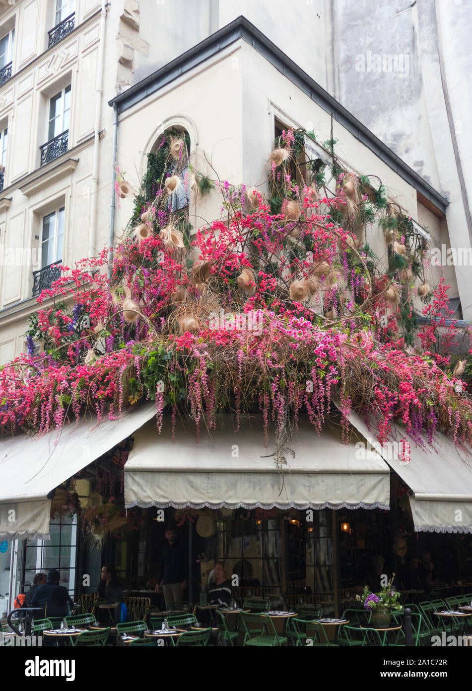 Sidewalk cafe with flowers and hats in Paris, France, 2019 Stock Photo ...