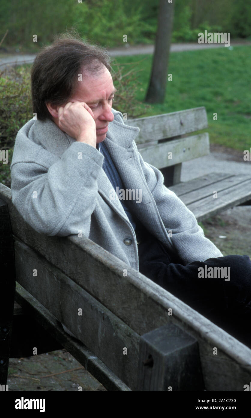 Lonely man sitting on bench hi-res stock photography and images - Alamy