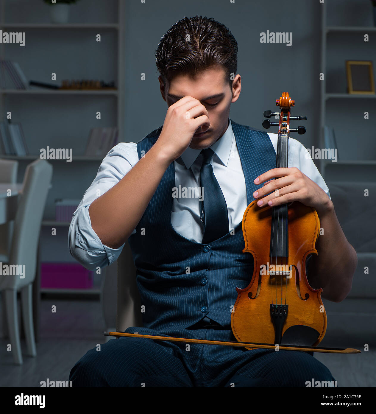 The young musician man practicing playing violin at home Stock Photo ...