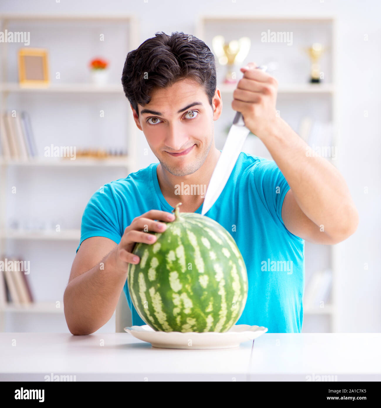 The man eating watermelon at home Stock Photo - Alamy