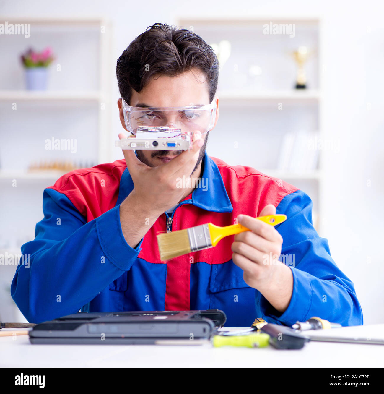 Repairman working in technical support fixing computer laptop ...