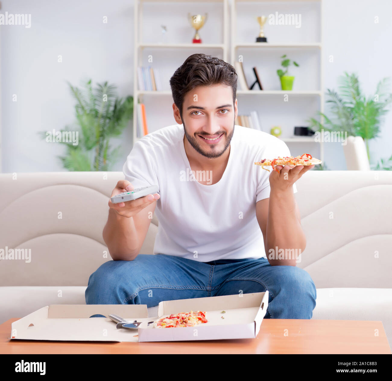The man eating pizza having a takeaway at home relaxing resting Stock ...