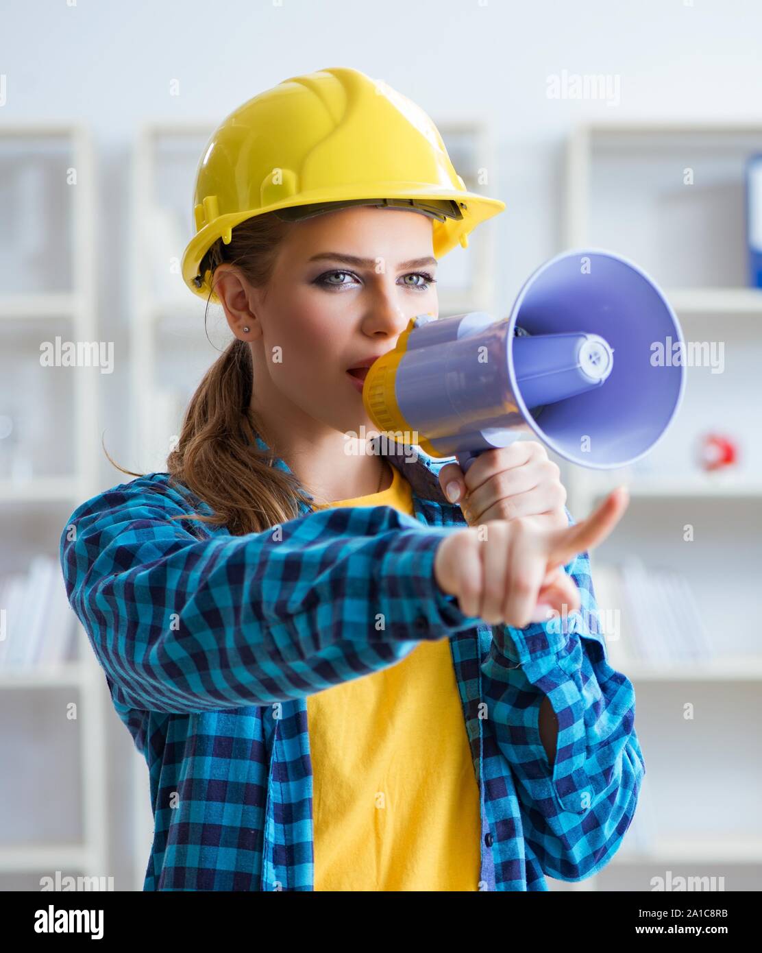 The angry building supervisor with megaphone Stock Photo - Alamy