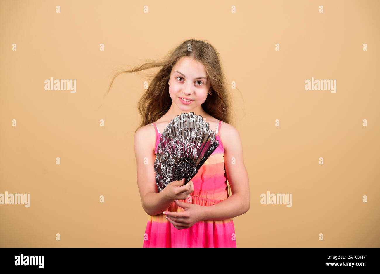 Girl fanning herself with fan. Air circulation. Art and culture ...
