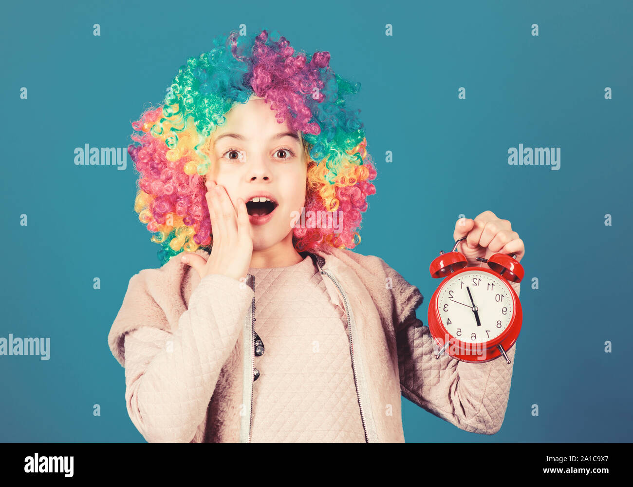 Kid colorful curly wig clown style hold alarm clock. I am not joking ...