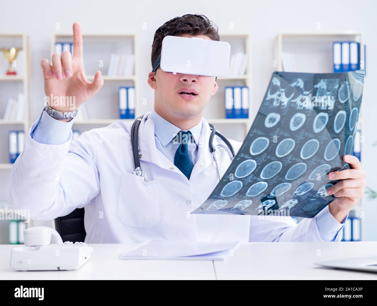The young doctor looking at mri scan through vr glasses Stock Photo - Alamy