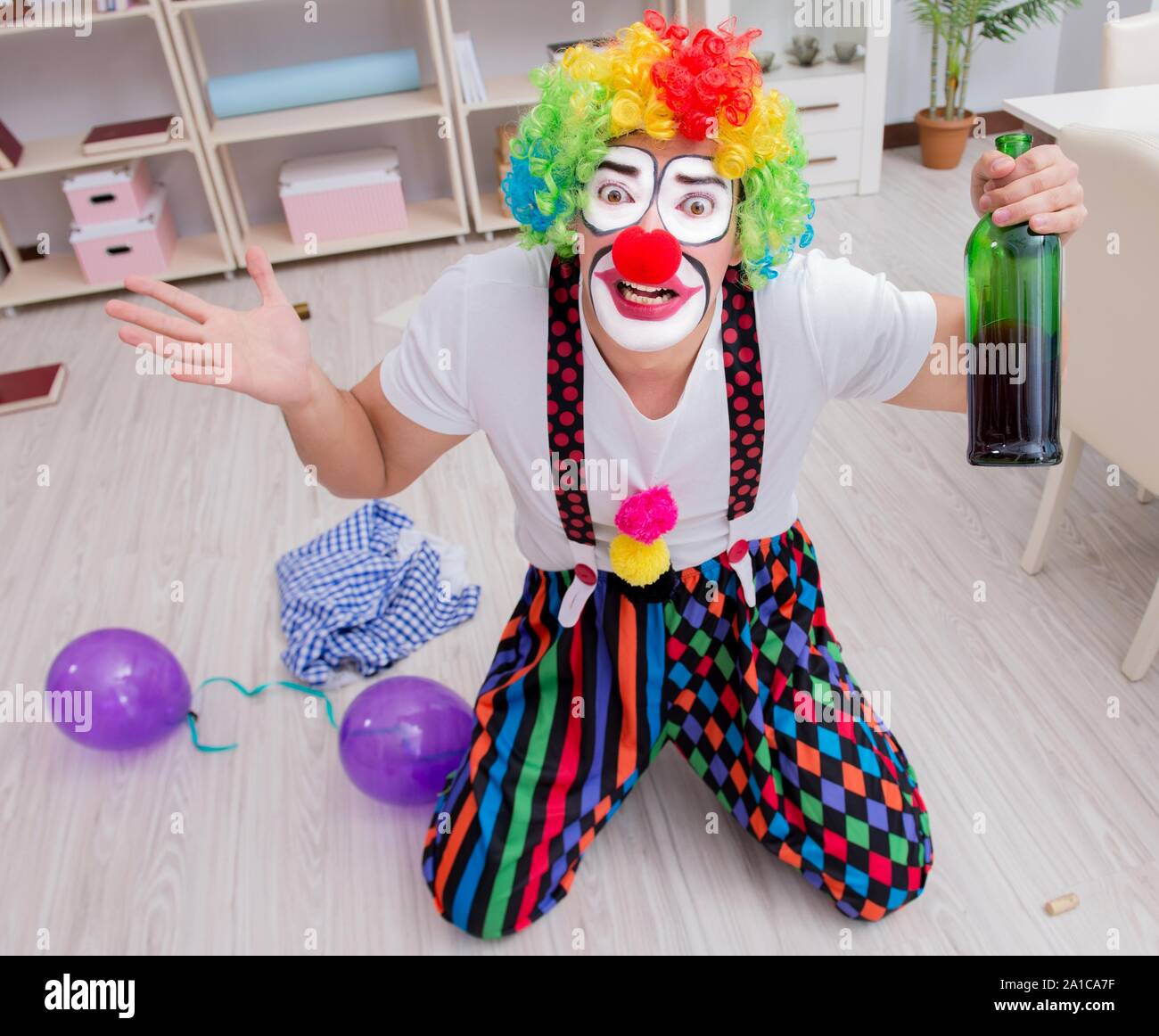 The drunk clown celebrating having a party at home Stock Photo - Alamy