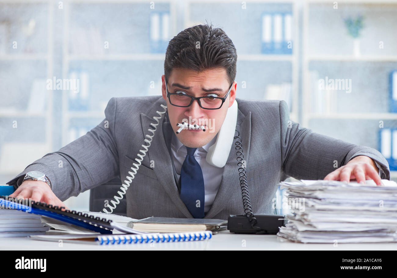 The businessman smoking in office at work Stock Photo - Alamy