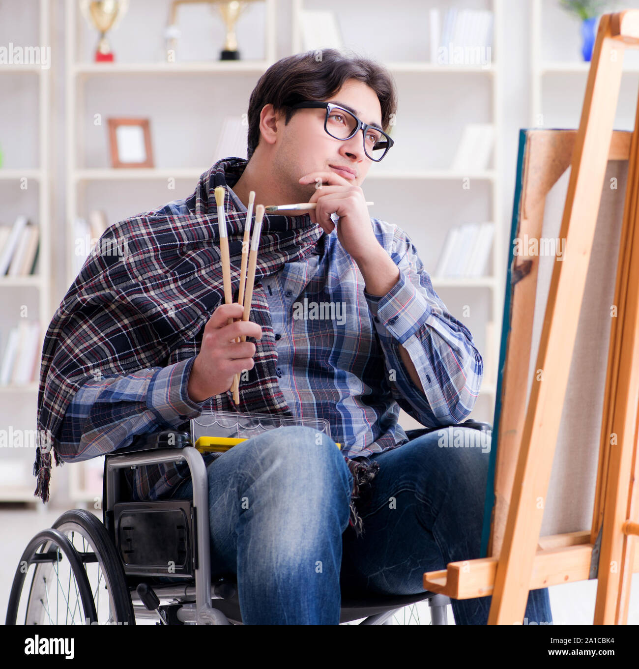The disabled artist painting picture in studio Stock Photo - Alamy