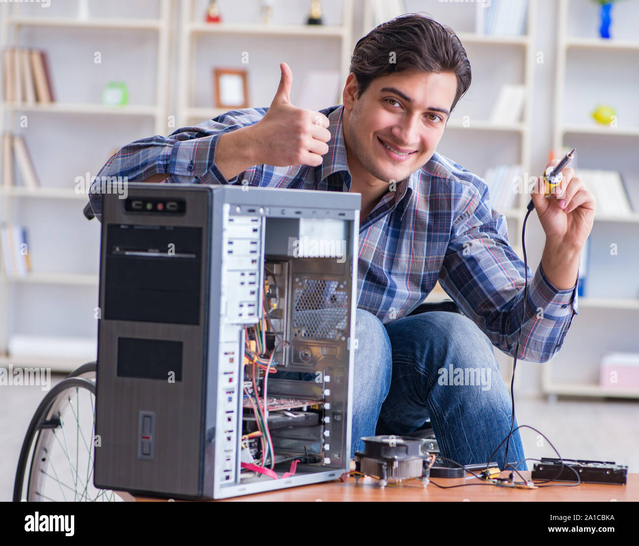 The man repairing pc with thumbs up Stock Photo - Alamy