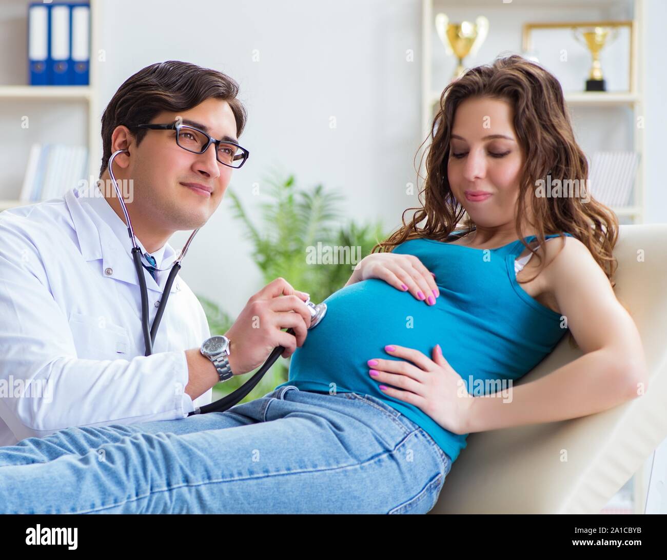 The doctor examining pregnant female patient in hospital Stock Photo ...