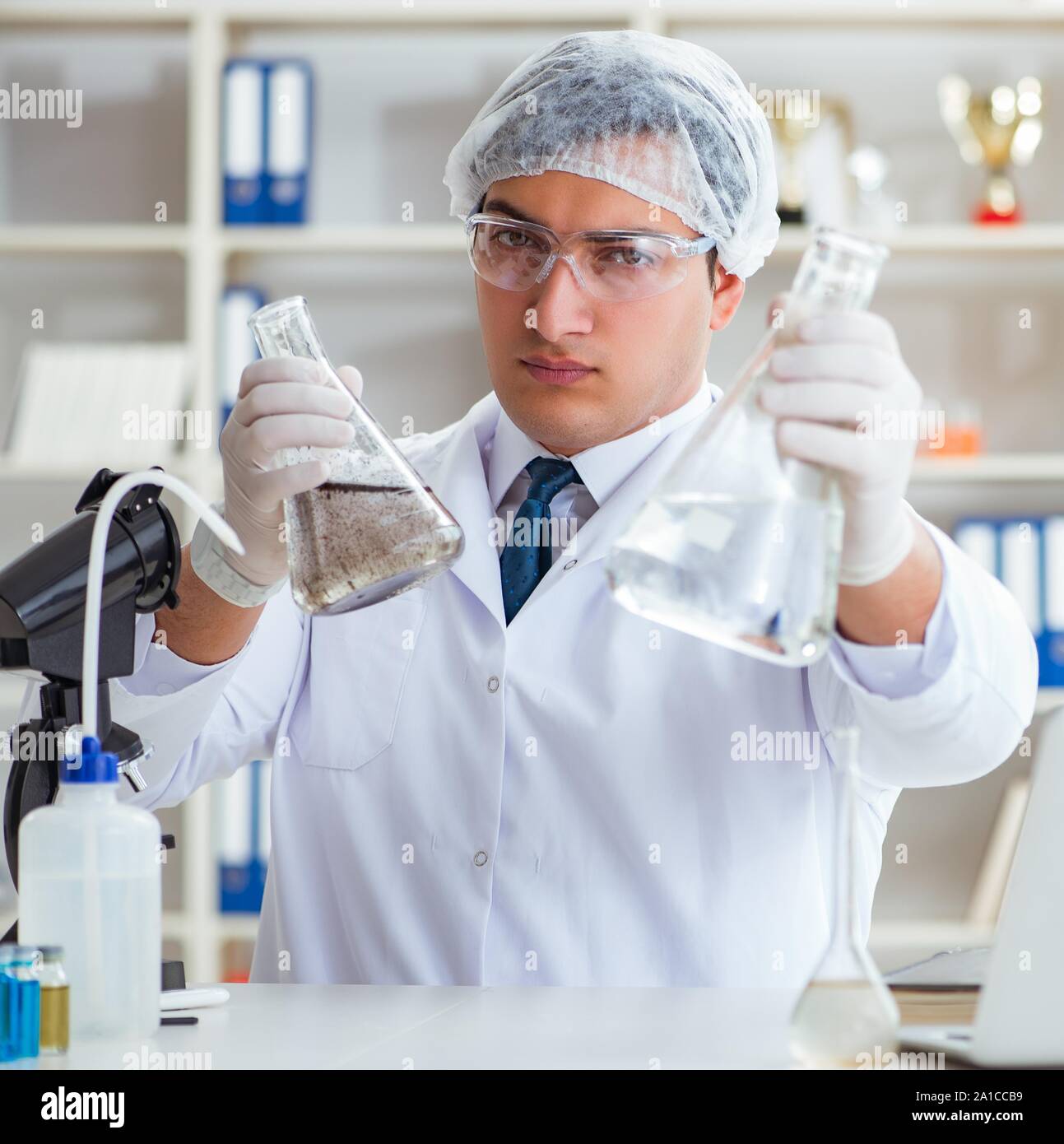 Young researcher scientist doing a water test contamination experiment ...