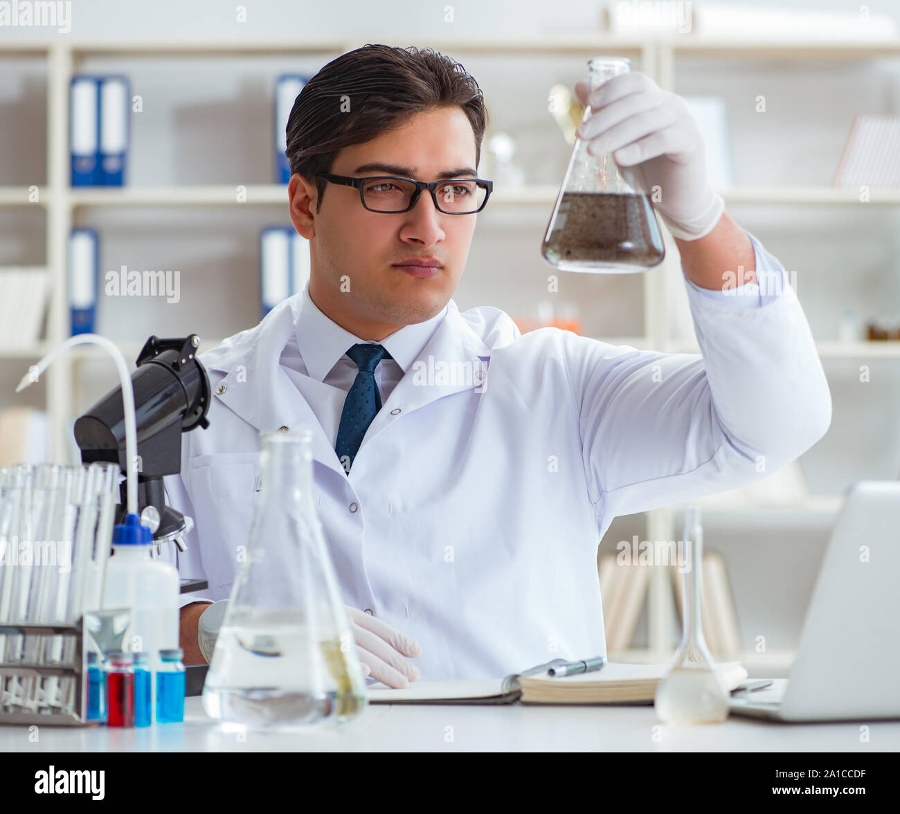 Young researcher scientist doing a water test contamination experiment ...
