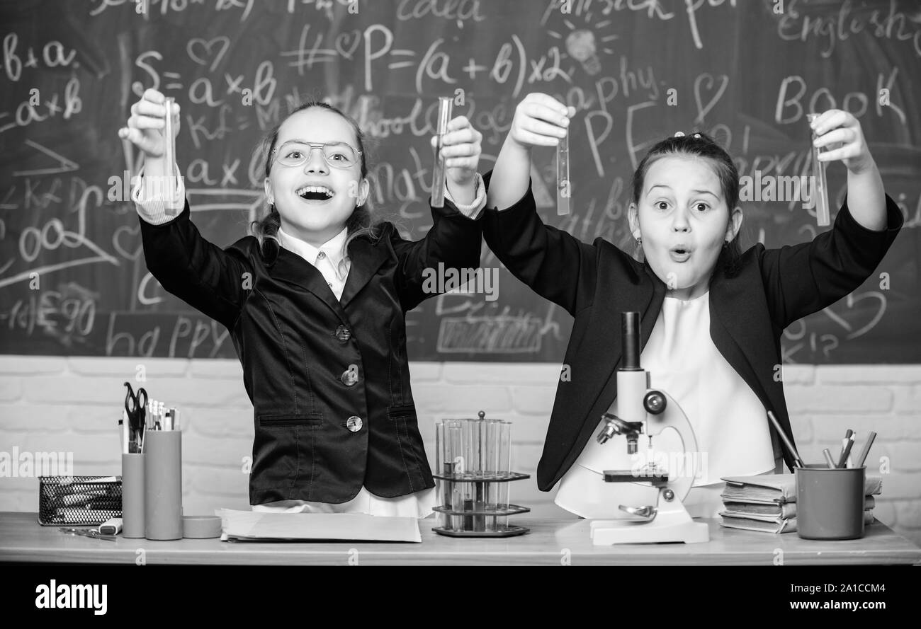 School experiment. Girls school uniform excited proving their ...