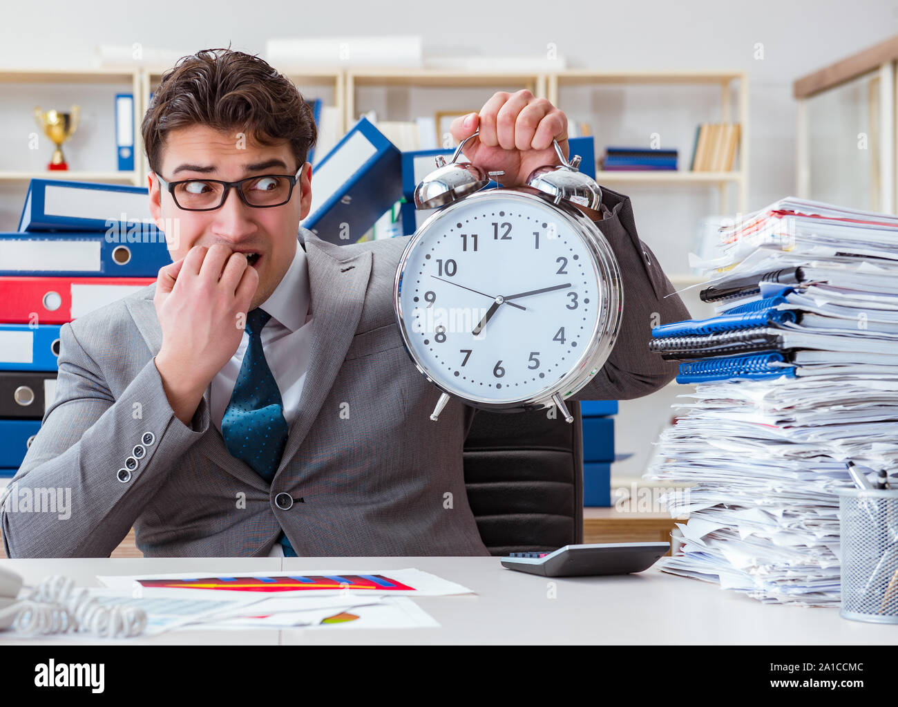 The businessman missing deadlines due to excessive work Stock Photo - Alamy