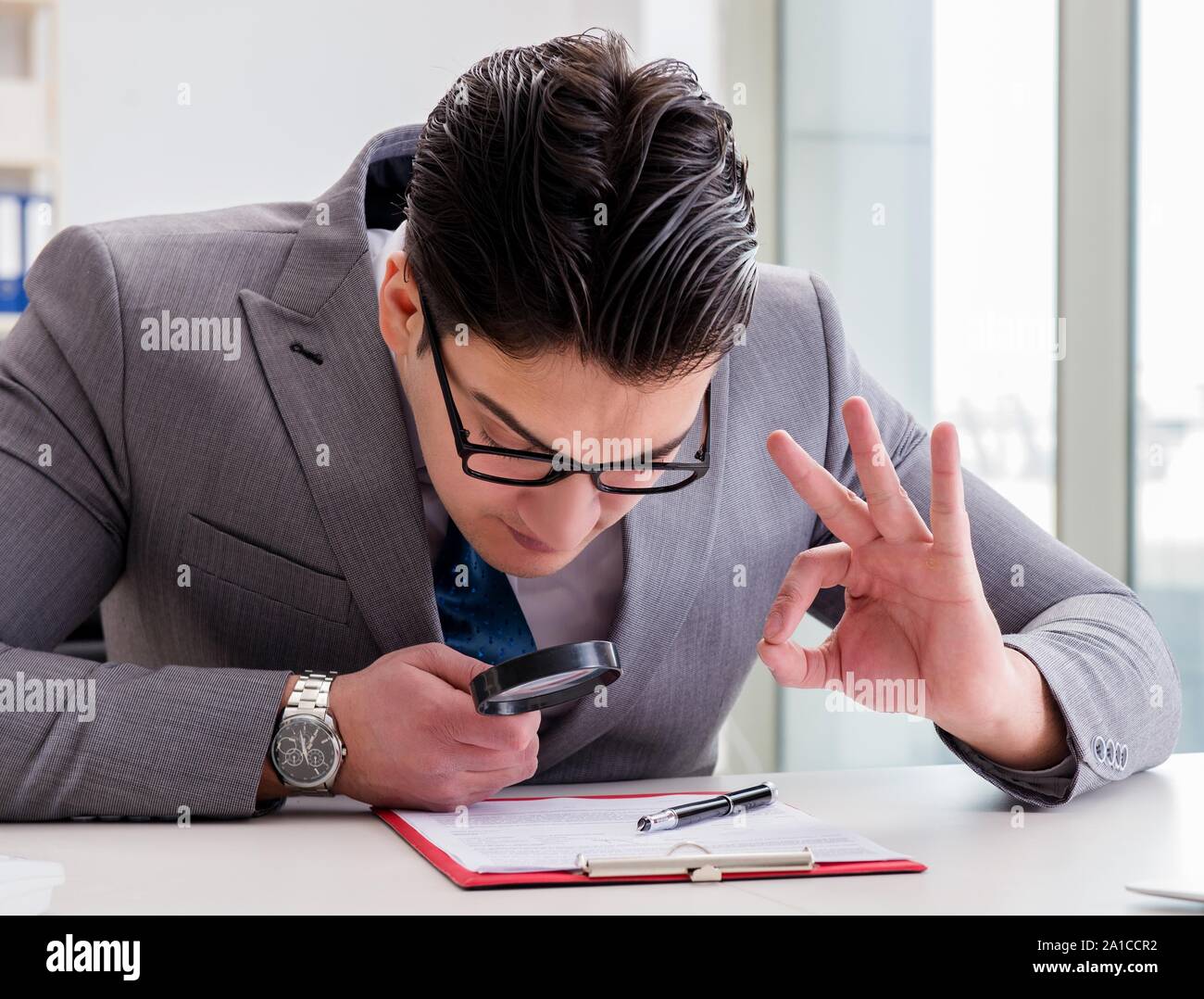 The man looking for errors and mistakes in report Stock Photo - Alamy