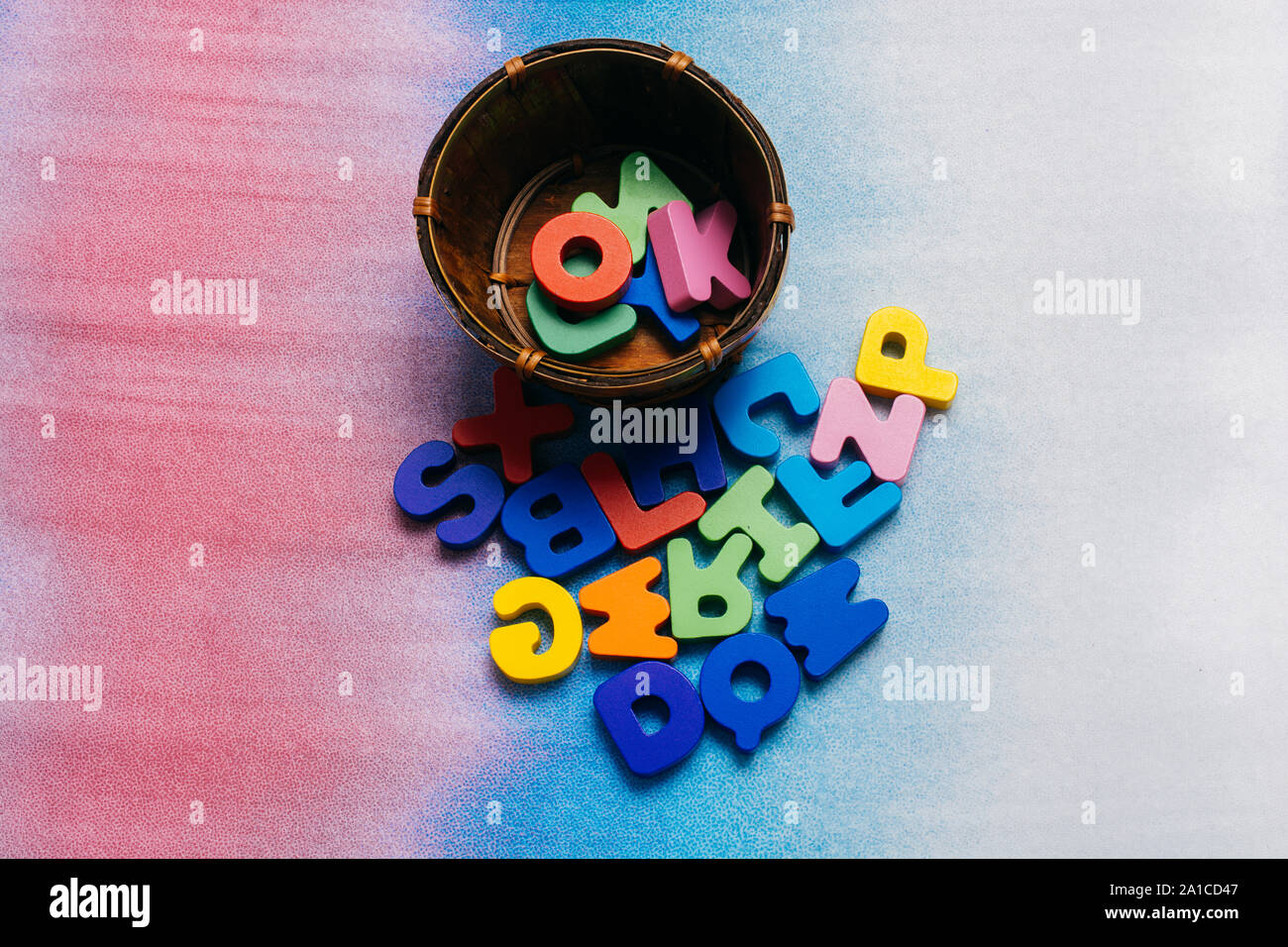 Colorful wooden letters in a container on a colorful background Stock ...