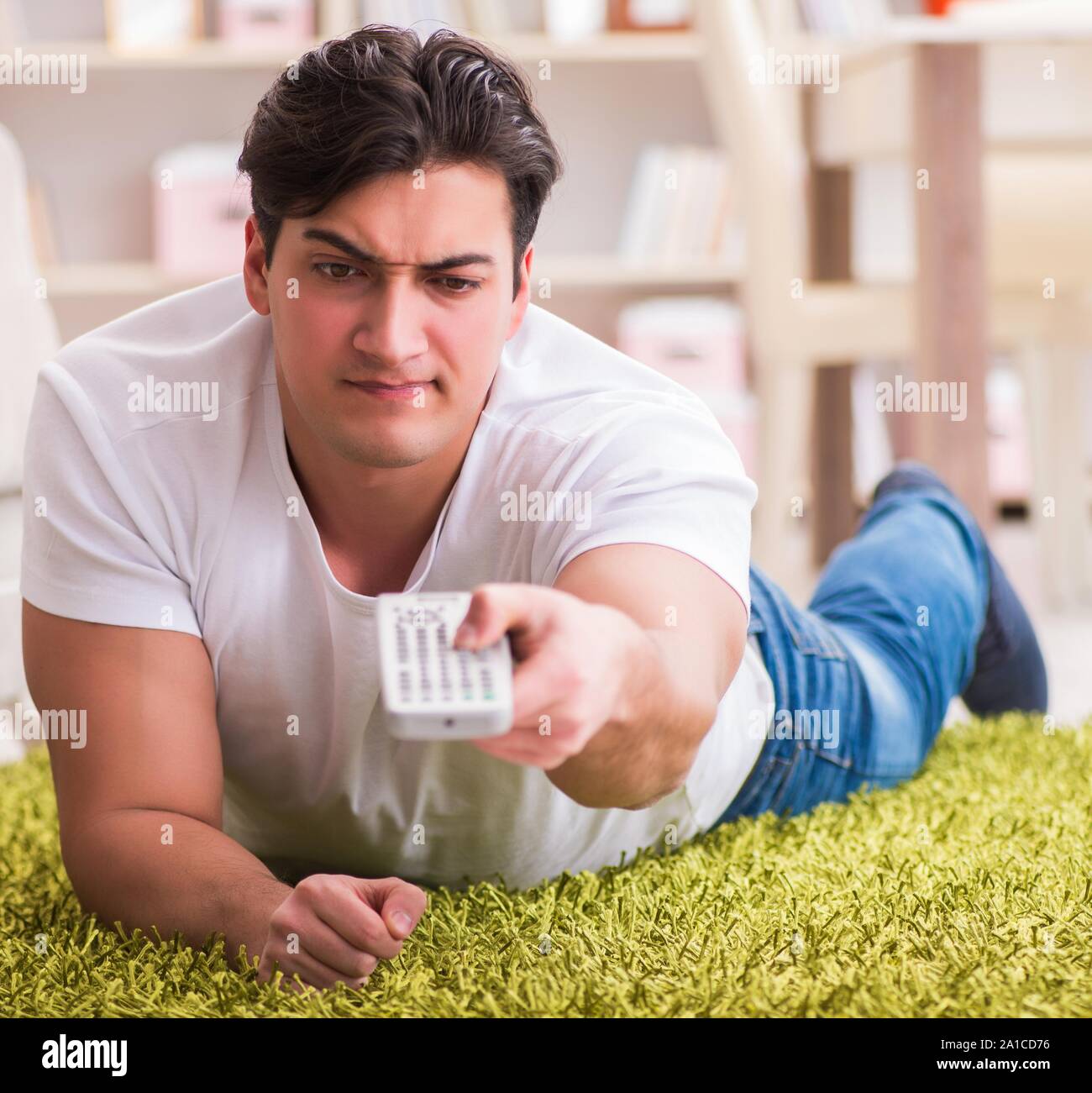 The man watching tv at home on floor Stock Photo - Alamy