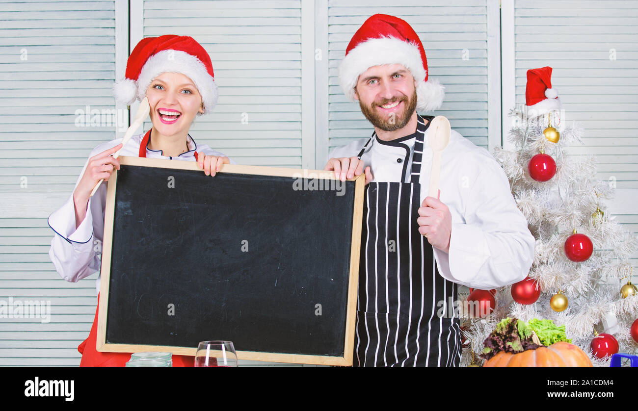 Menu for our family. Man and woman chef santa hat near christmas tree ...