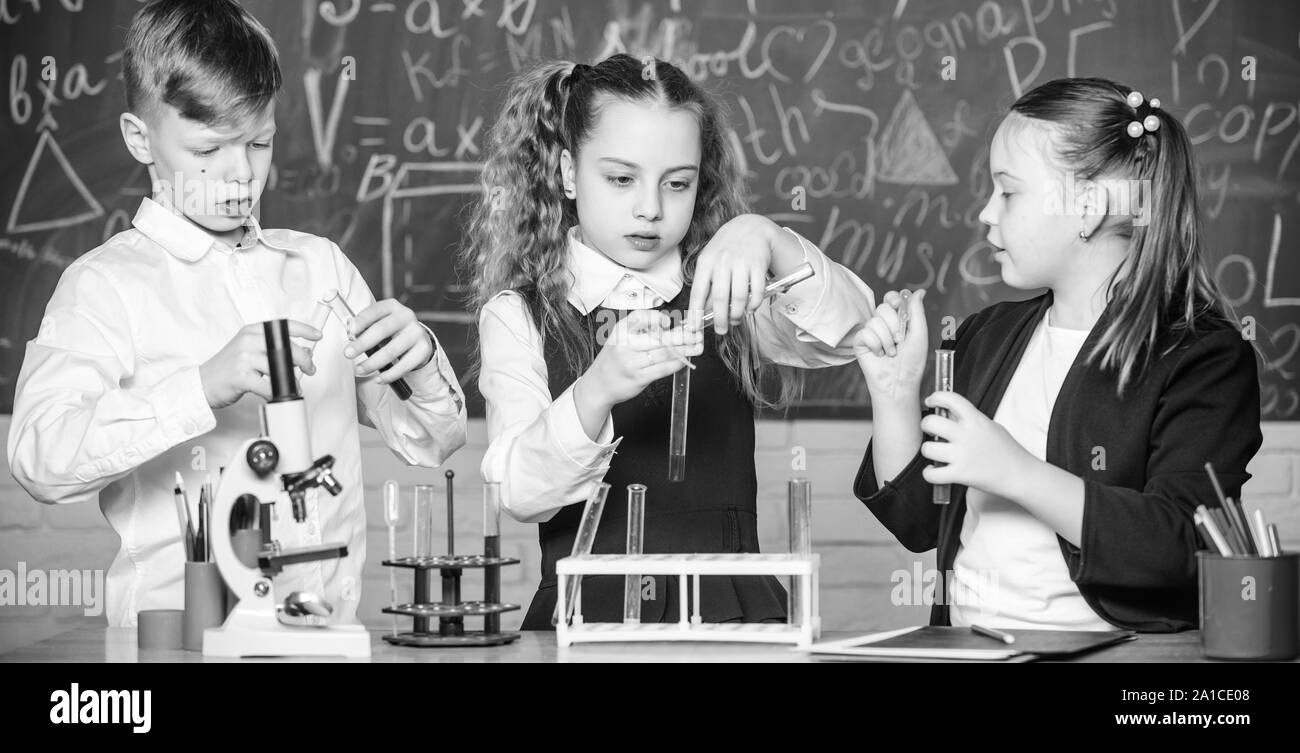 students doing experiments with microscope. Happy children. Chemistry ...