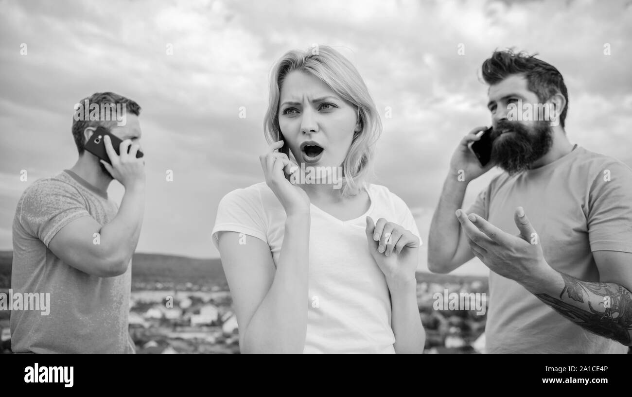 Talking with friends. Friends using phone. 3 young people on ph Stock ...