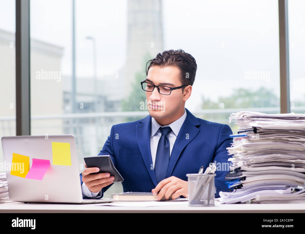 The workaholic businessman overworked with too much work in office ...