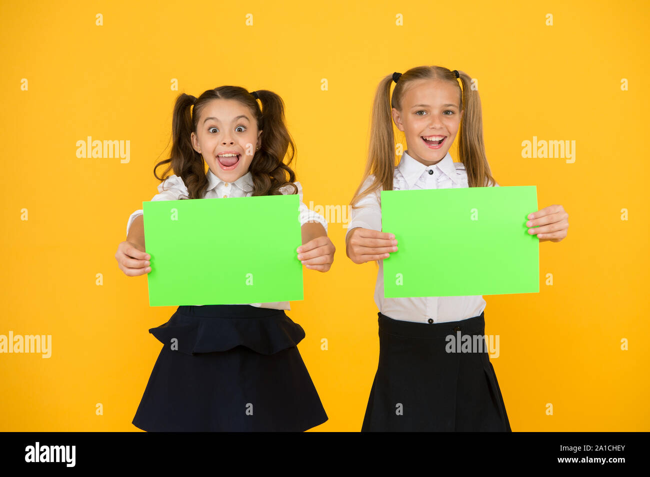 Advertising idea for school. Happy girls holding paper sheets for ...