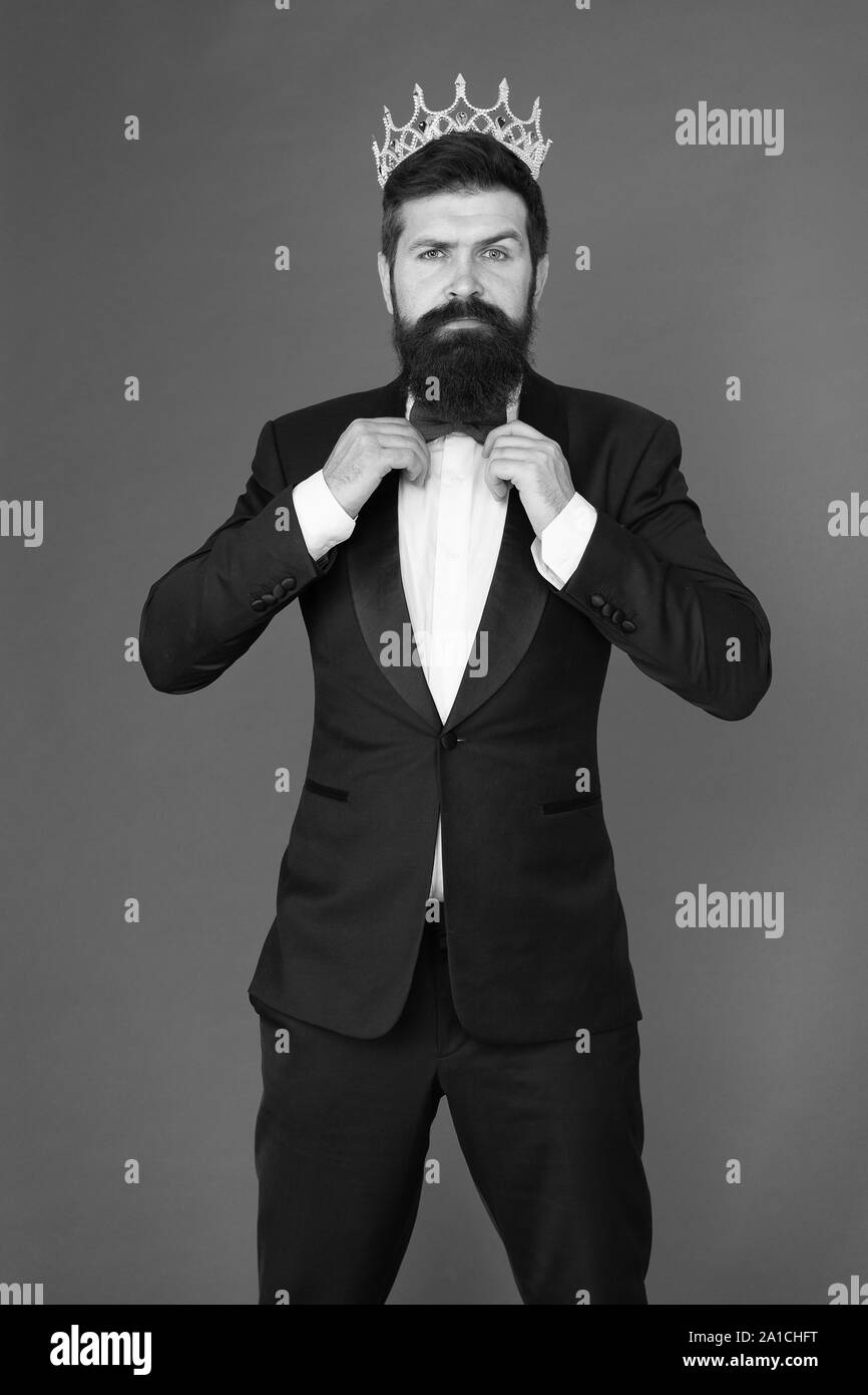 Feeling superior. Man bearded handsome guy in formal suit golden crown ...